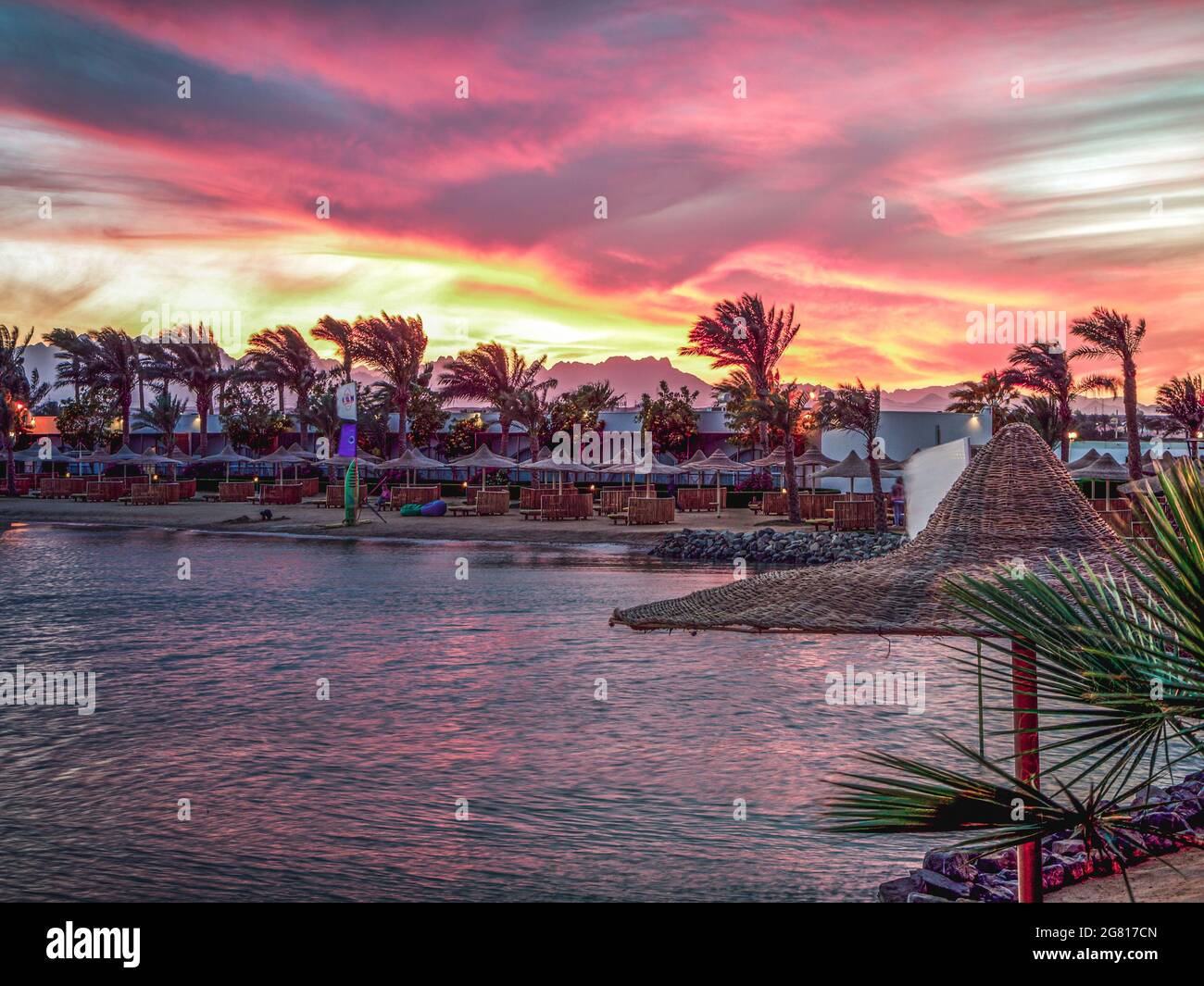 Sunset over the red sea palm tree silhuettes hotel in Hurgada, Egypt ...