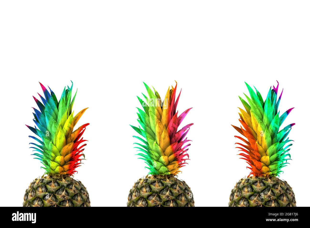 Three pineapples with colorful leaves on a white background. Copy space ...