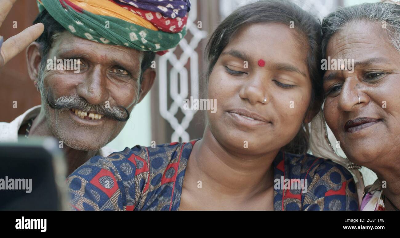 Group of South Asian people in traditional Indian clothing taking a ...