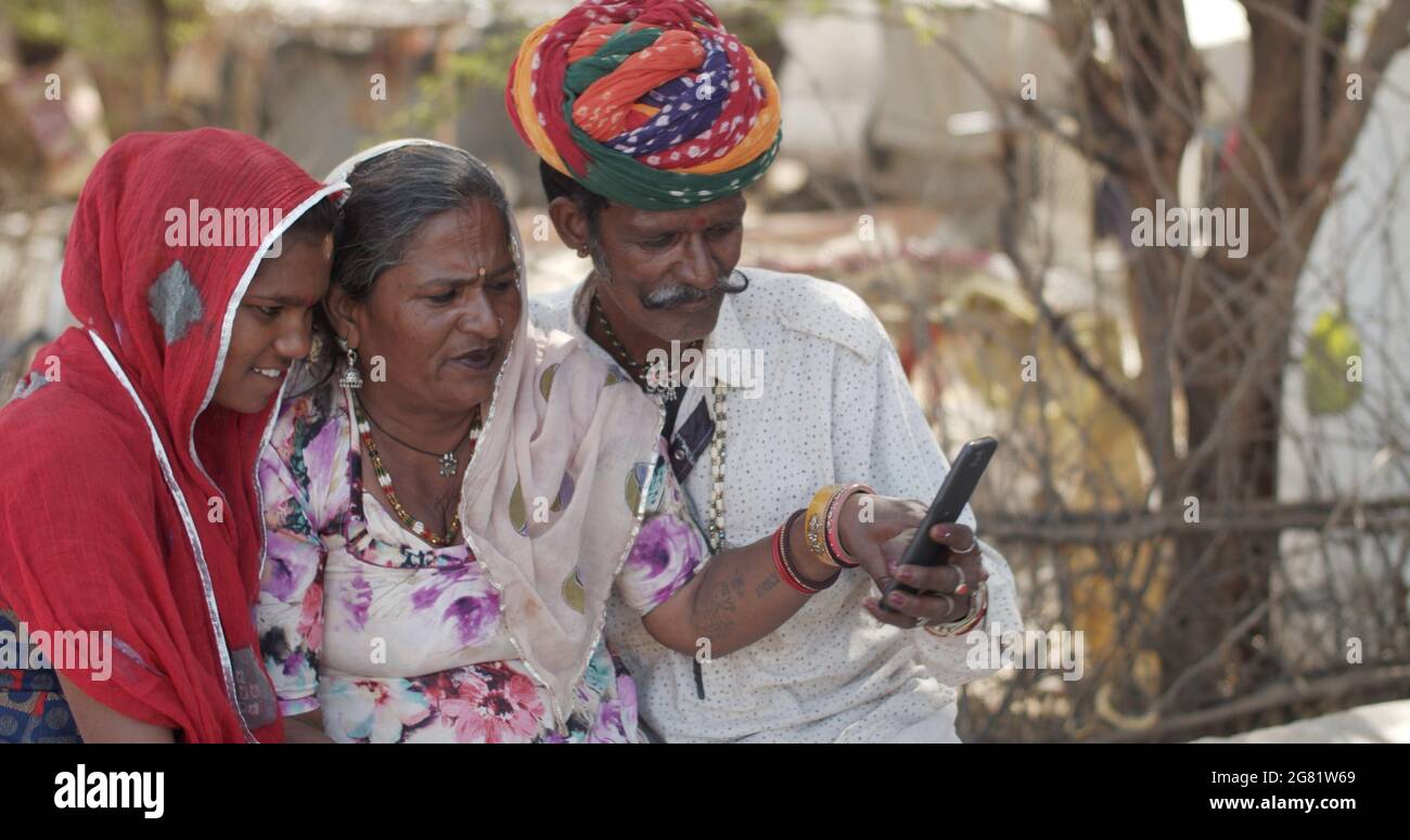 Group of South Asian people in traditional Indian clothing taking a ...