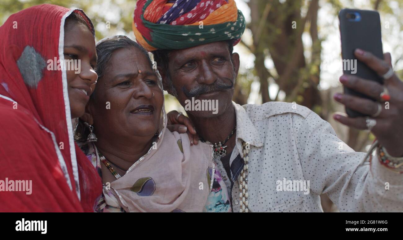 Group of South Asian people in traditional Indian clothing taking a ...