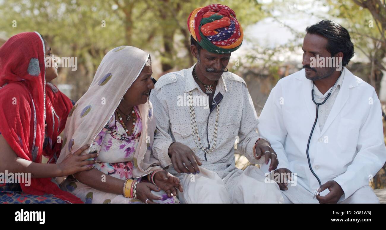 Group of South Asian people in traditional Indian clothing having a ...