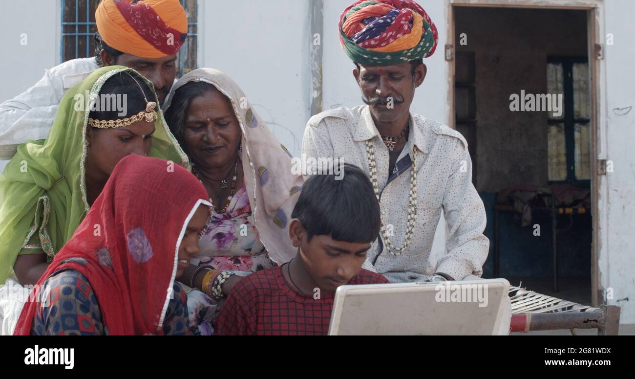 Group of South Asian people in traditional Indian clothing using a ...