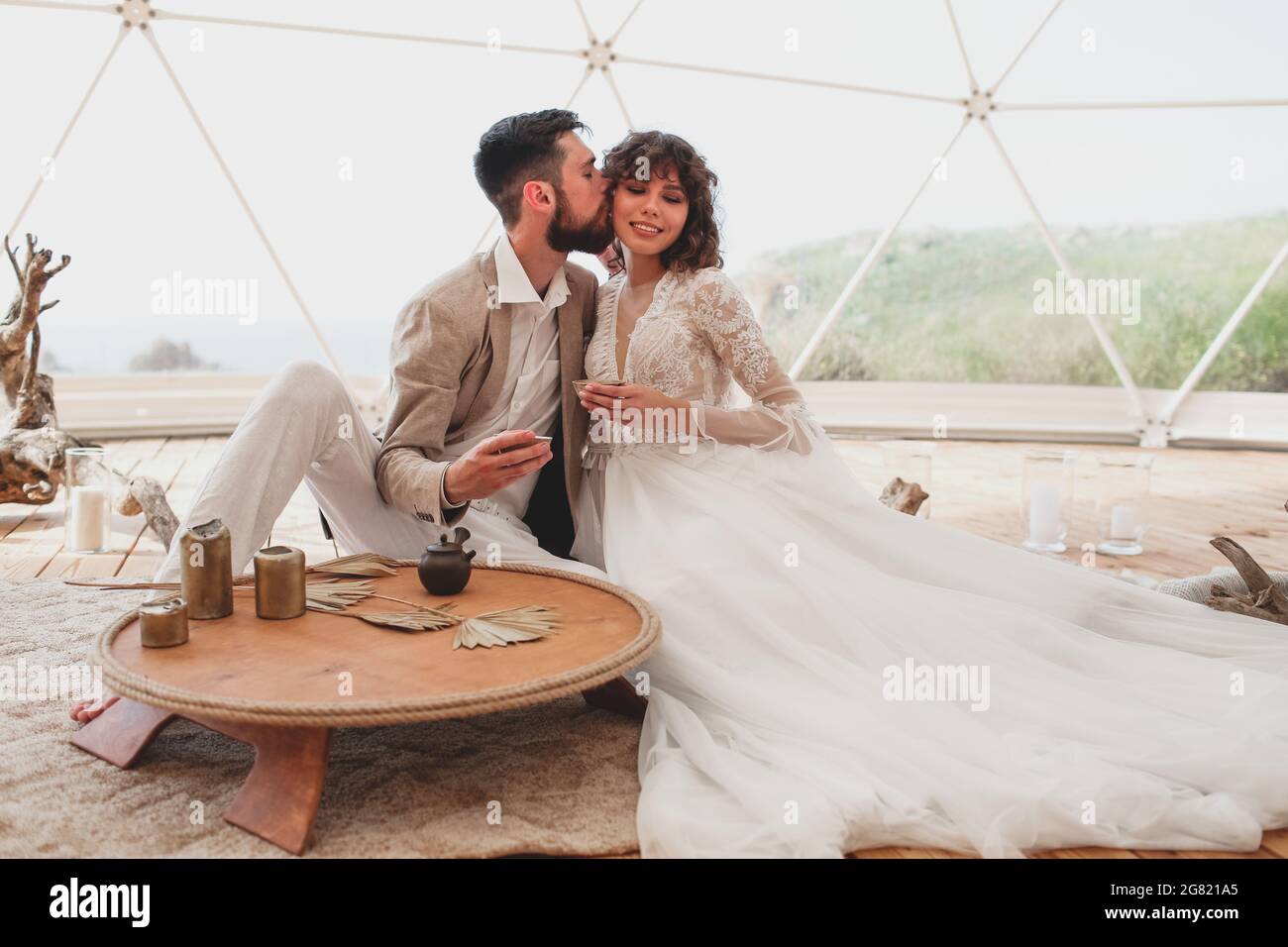 Tea ceremony at a boho wedding. Bride and groom in boho Stock Photo - Alamy