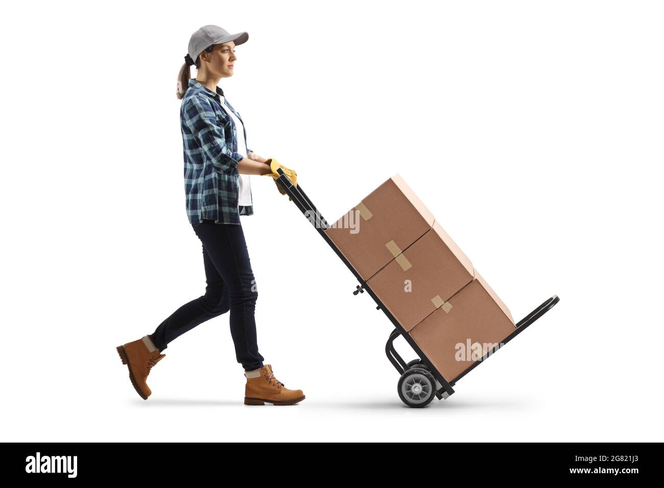 Full length profile shot of a woman pushing a hand truck with cardboard ...