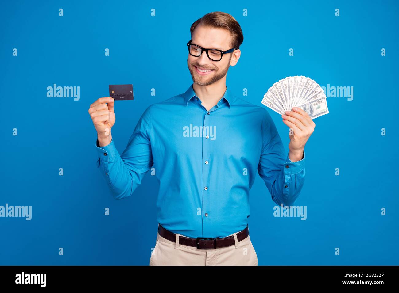 Photo of young business man happy positive smile hold bank card income ...