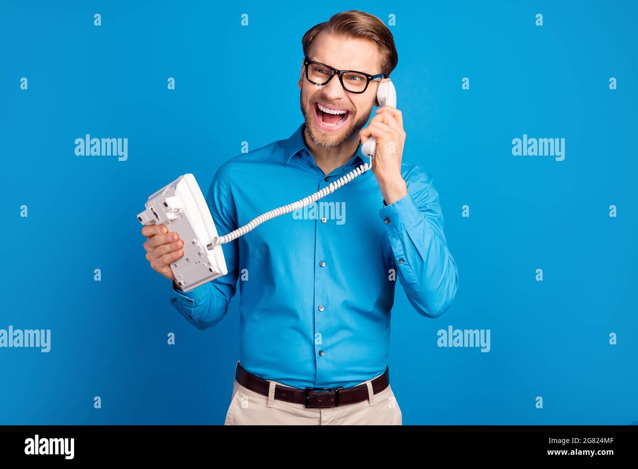 Photo of young man unhappy upset call speak yell phone angry mad ...