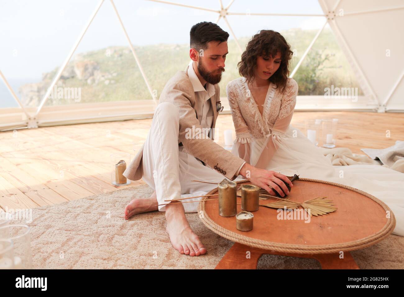Tea ceremony at a boho wedding. Bride and groom in boho Stock Photo - Alamy