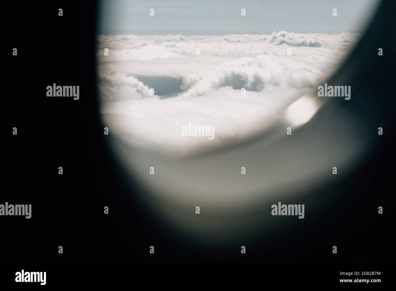 Snow-capped mountains outside a plane window Stock Photo - Alamy
