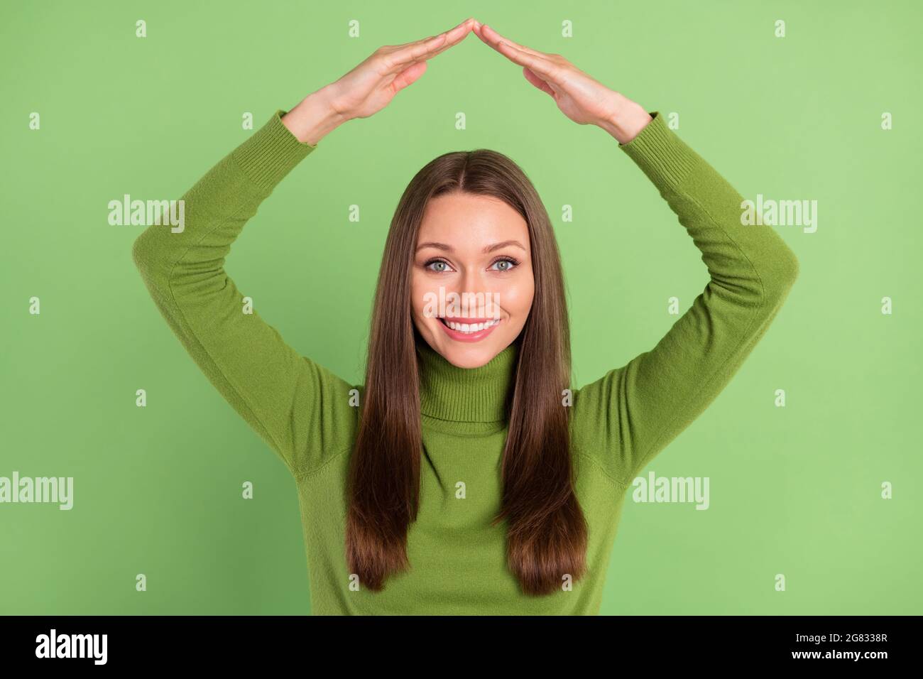 Photo portrait happy woman keeping hands over head new insurance ...