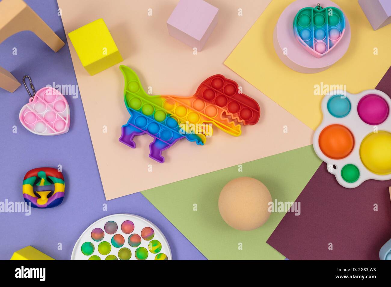 Popular silicone anti-stress pop-it toys for a child on the yellow ...