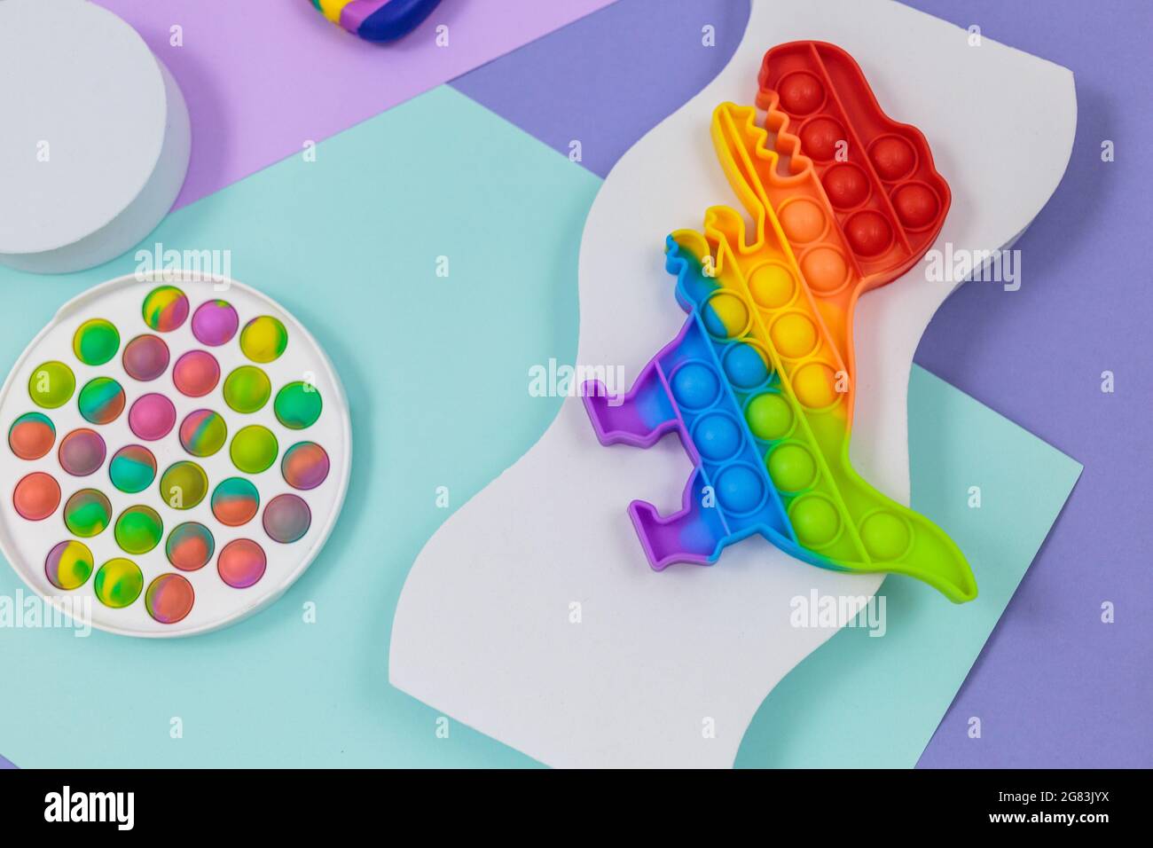 Popular silicone anti-stress pop-it toys for a child on the yellow ...