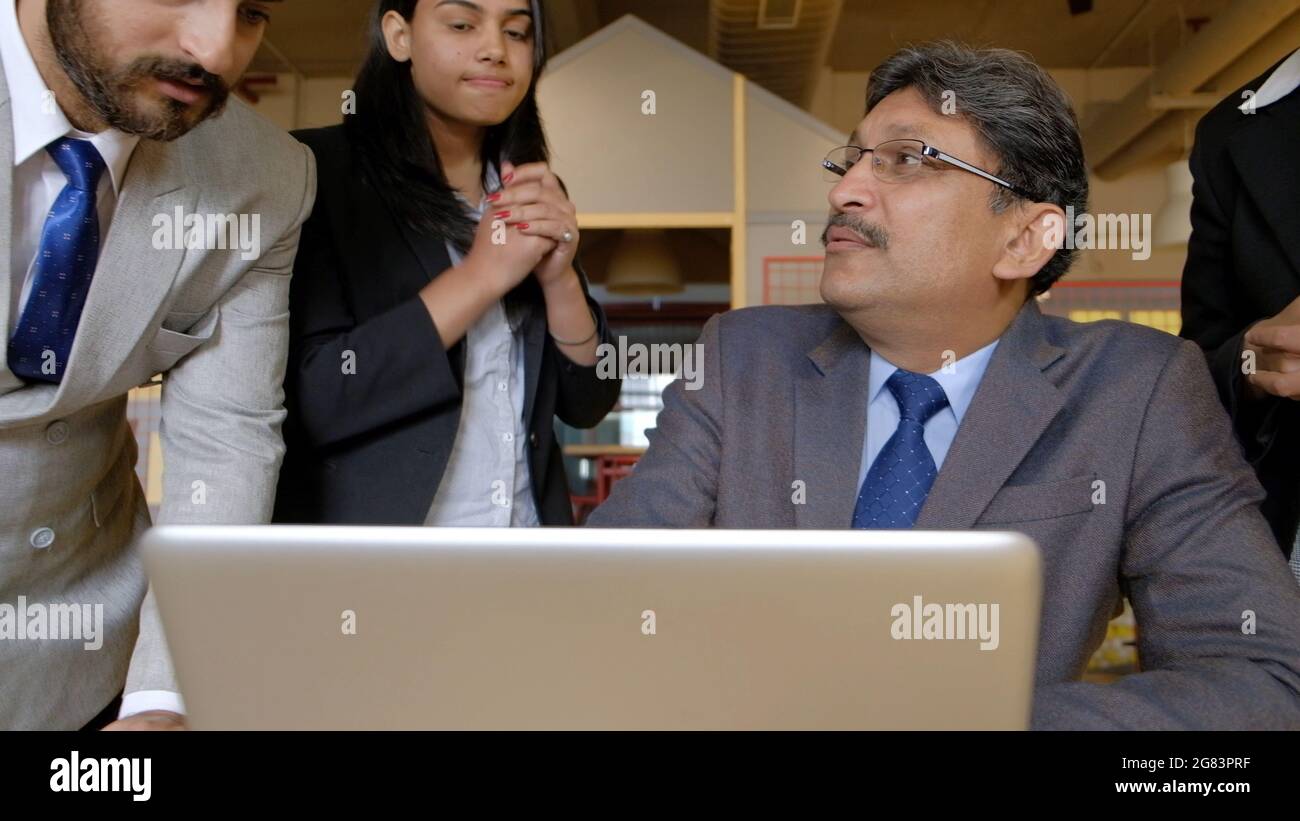 Senior boss manager giving corrections in the presentation showed by ...