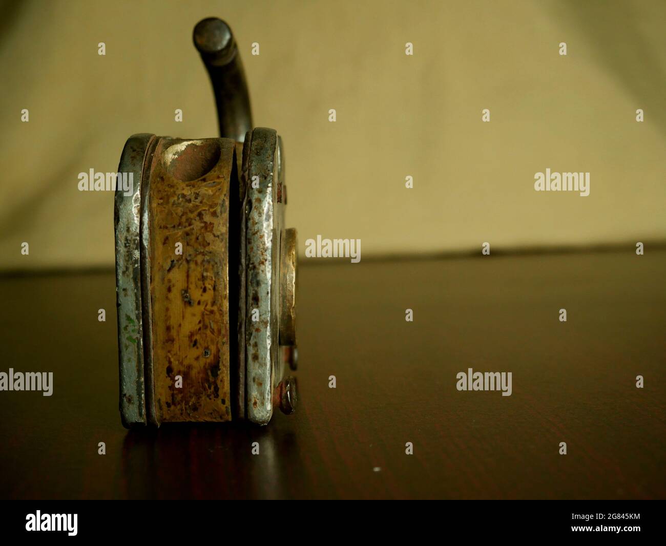 Very old lock presented on wooden floor. Ancient product made with hand ...