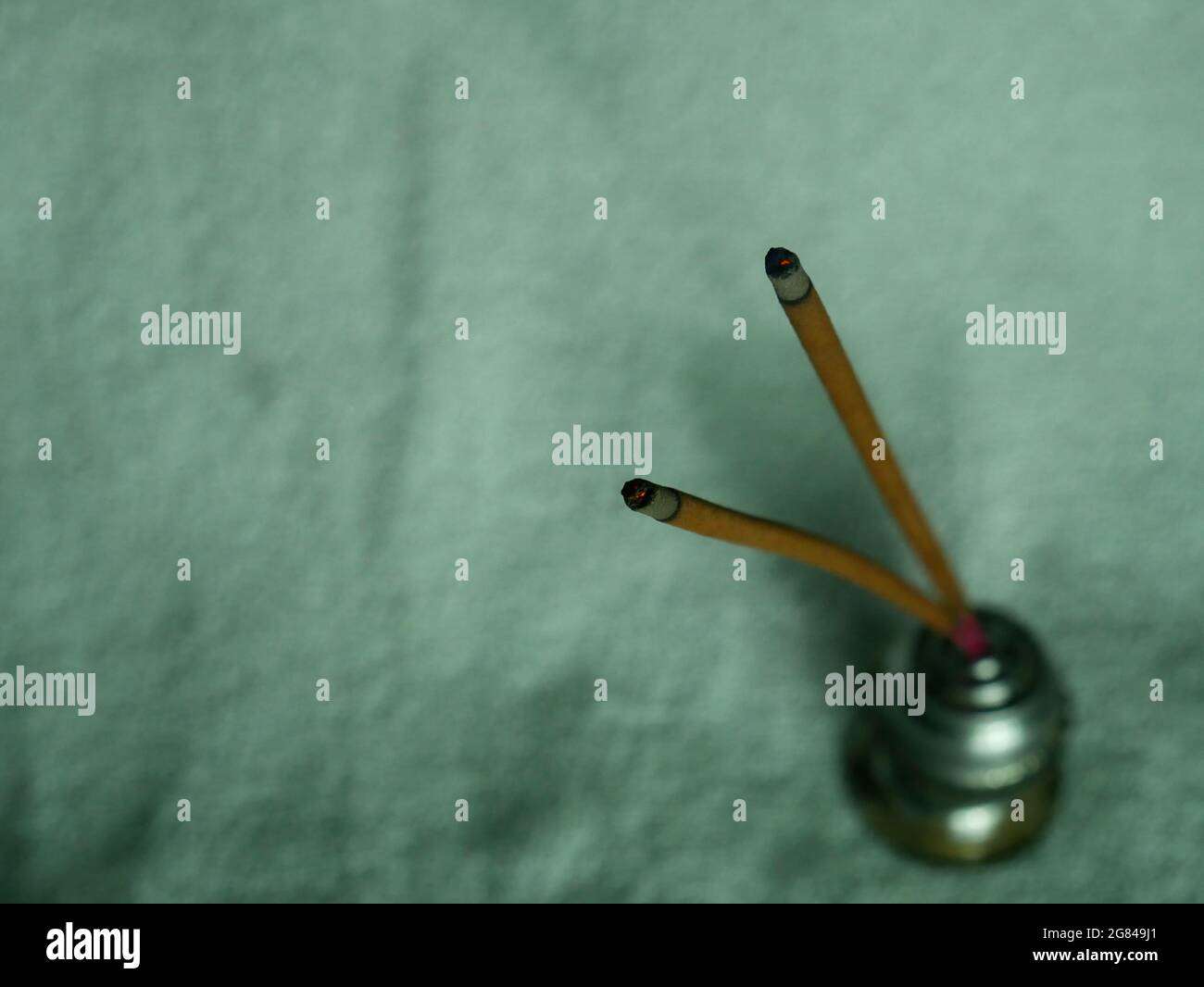 religious fragrance sticks burning with red fire point focus shot at ...