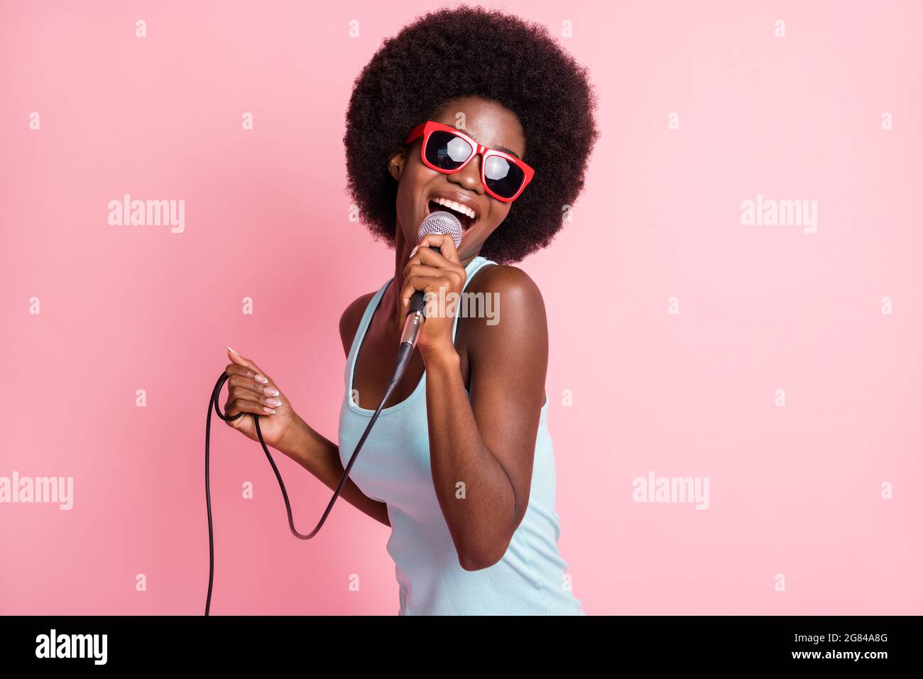Photo of happy funky dark skin young woman hold sing mic music lover ...