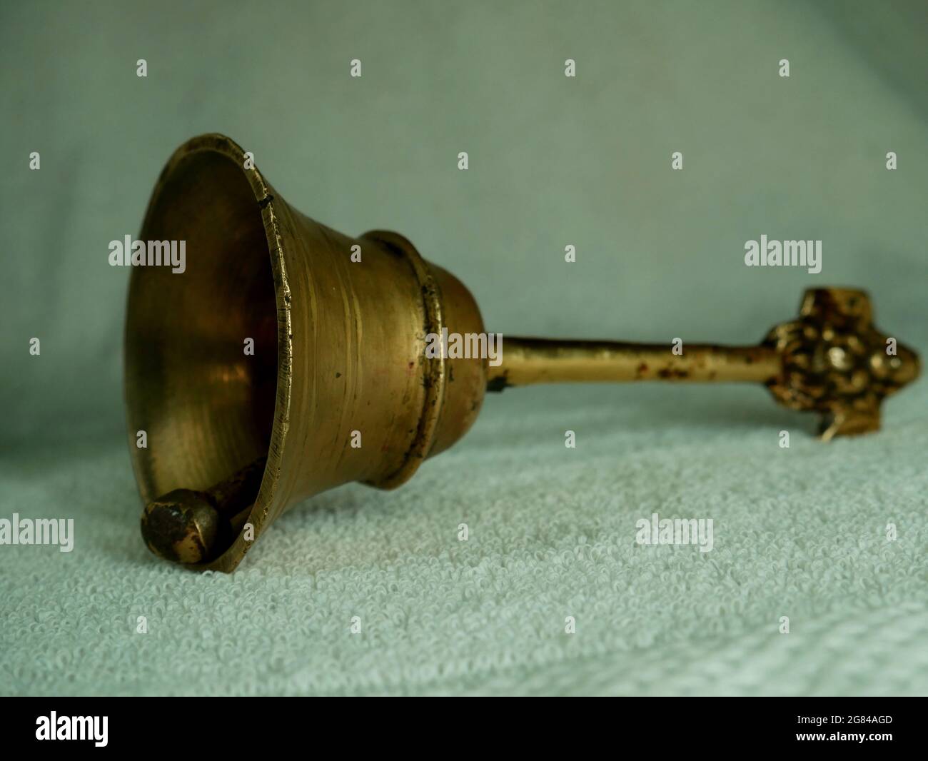 Ancient religious hand well brass metal isolated at white backdrop ...