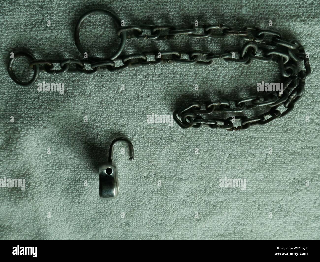 Iron chain with lock Displaying at white fabric, Mechanic concept image ...