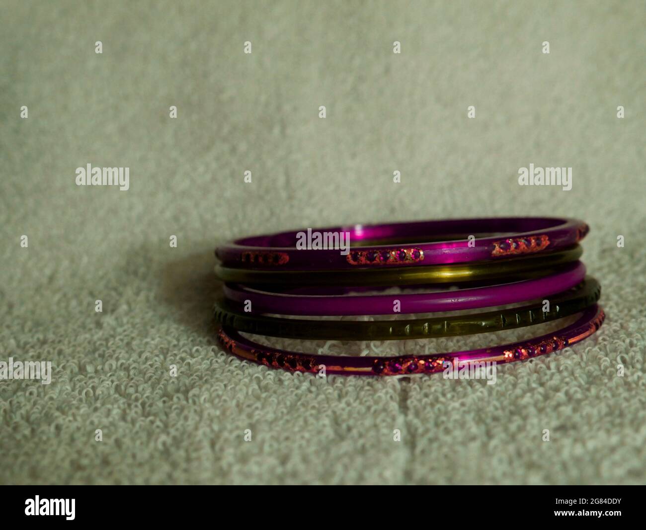 Beautiful purple color bangle presenting isolated at white backdrop ...