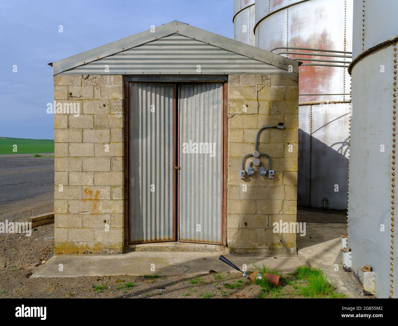 A concrete shed with a metal roof at a grain elevator in southeastern ...