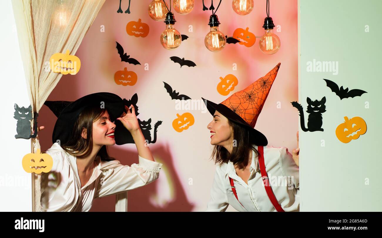 Two cheerful young women in witch halloween costumes dancing. Halloween ...