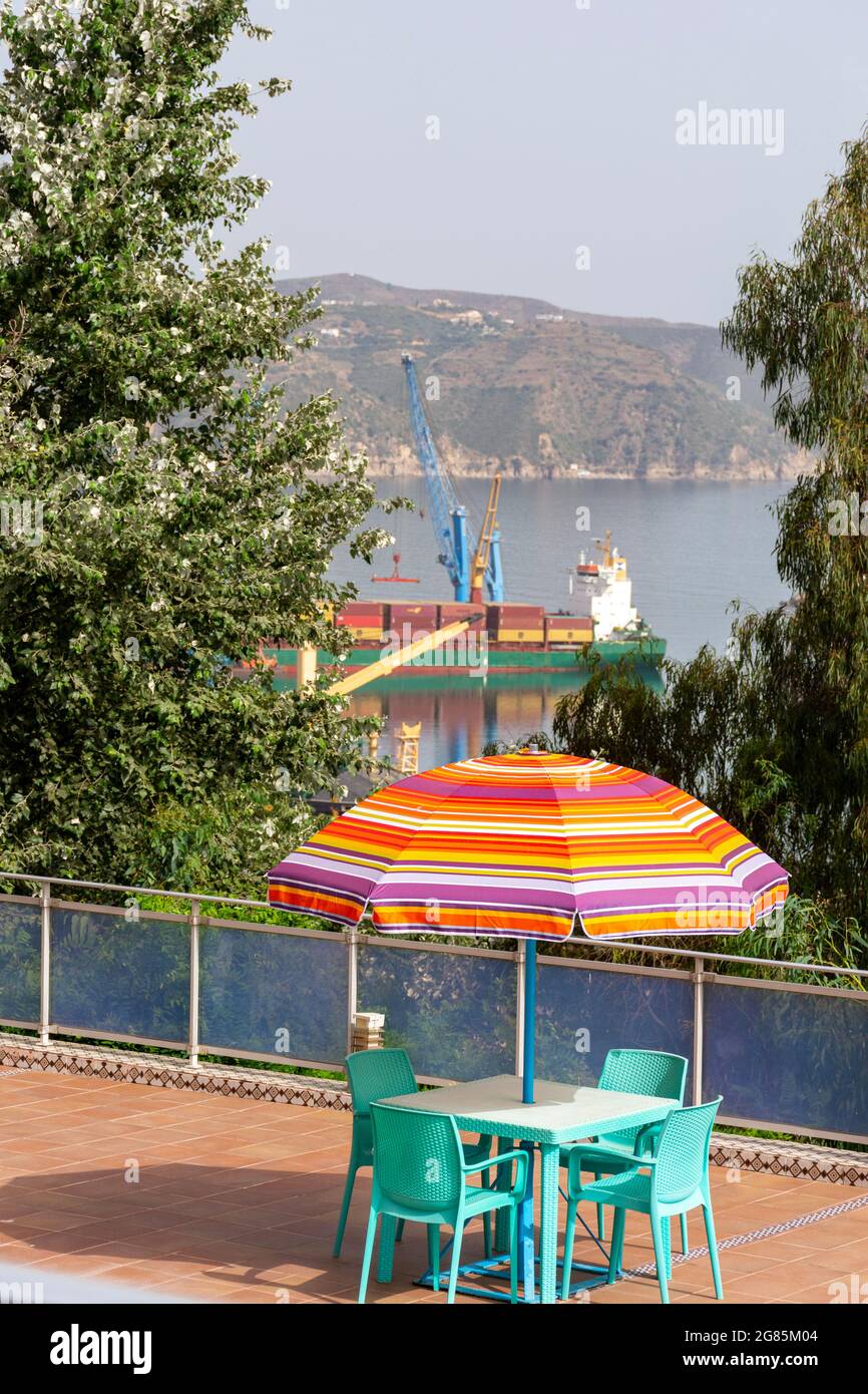 Colorful parasol with plastic chairs Stock Photo - Alamy