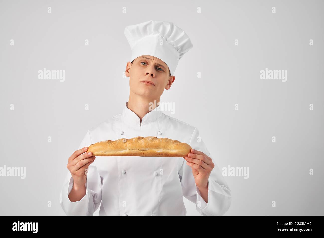 Cheerful male chef biting a loaf cooking food bakery Stock Photo - Alamy
