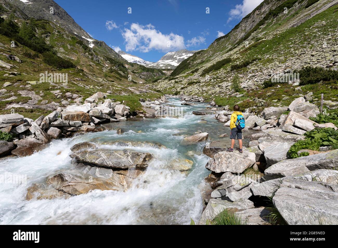 Boy standing near glacier stream in Hohe tauern national park while ...