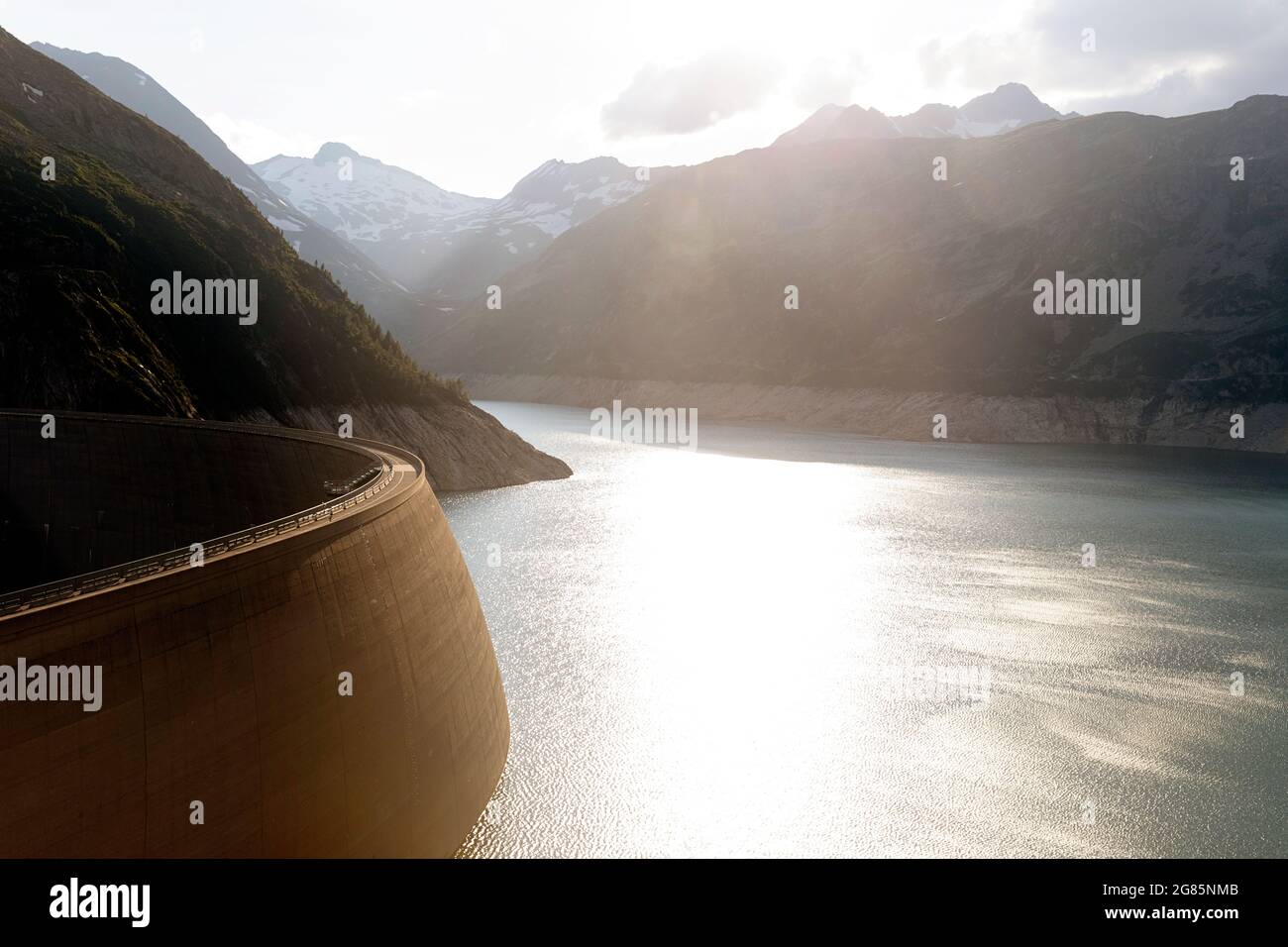 Aerial evening view of alpine dam and reservoir lake Kolnbreinsperre ...
