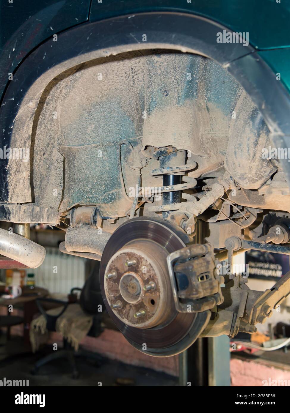 The rear wheel hub, shock absorber and caliper are old and rusty. In ...