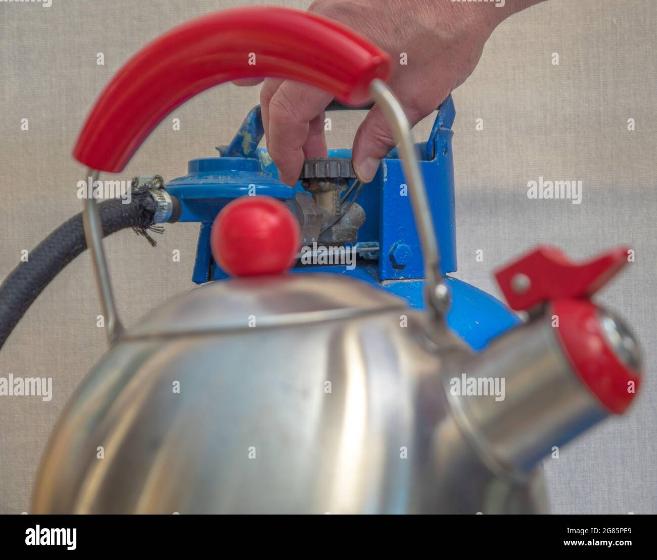 Hand turning on a kettle hi-res stock photography and images - Alamy