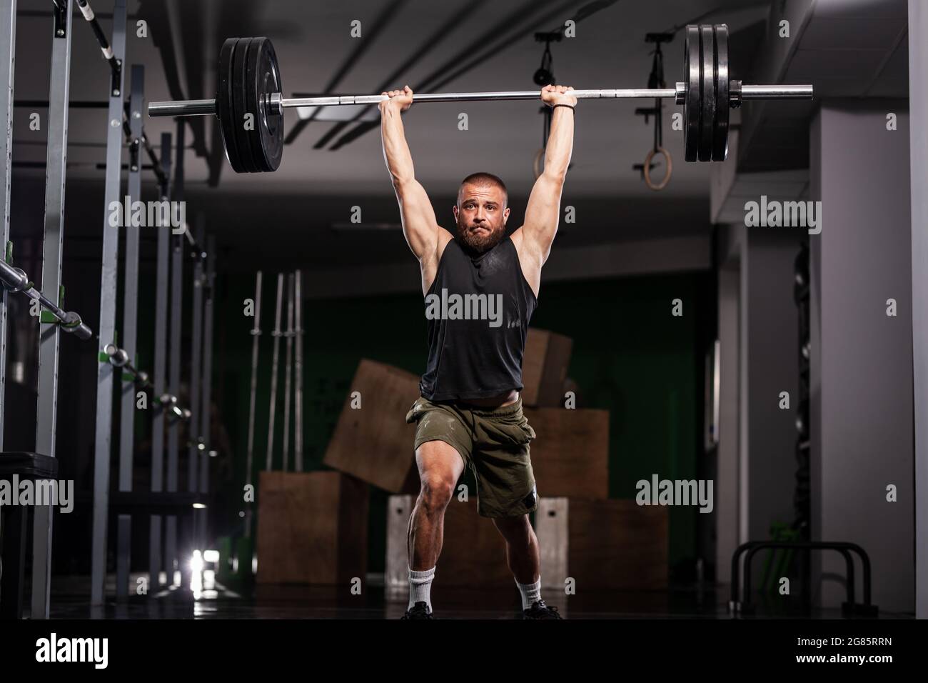 Muscular athlete lifting very heavy barbell Stock Photo - Alamy