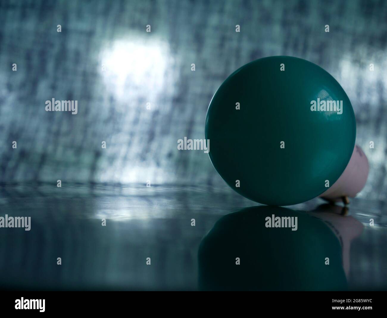 turquoise blue color electric bulb zero watt side view with reflection ...