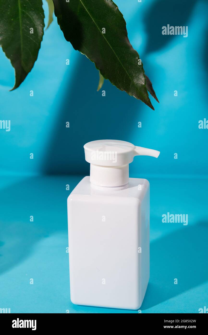 Vertical shot of a liquid soap on the blue background Stock Photo - Alamy