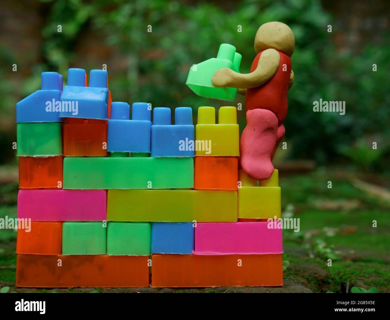 Clay toy man making plastic playing blocks building at natural park ...
