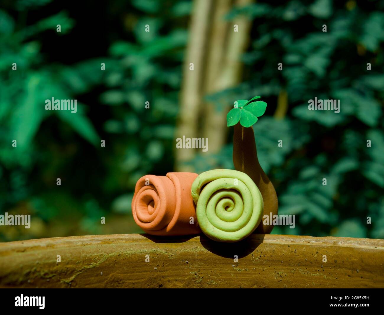 hand created clay art joint flower presented at natural park background ...