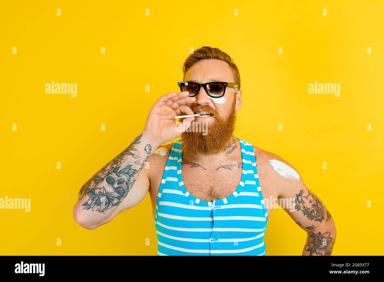 man with beard,tattoo and swimsuit smokes a cigarette Stock Photo - Alamy