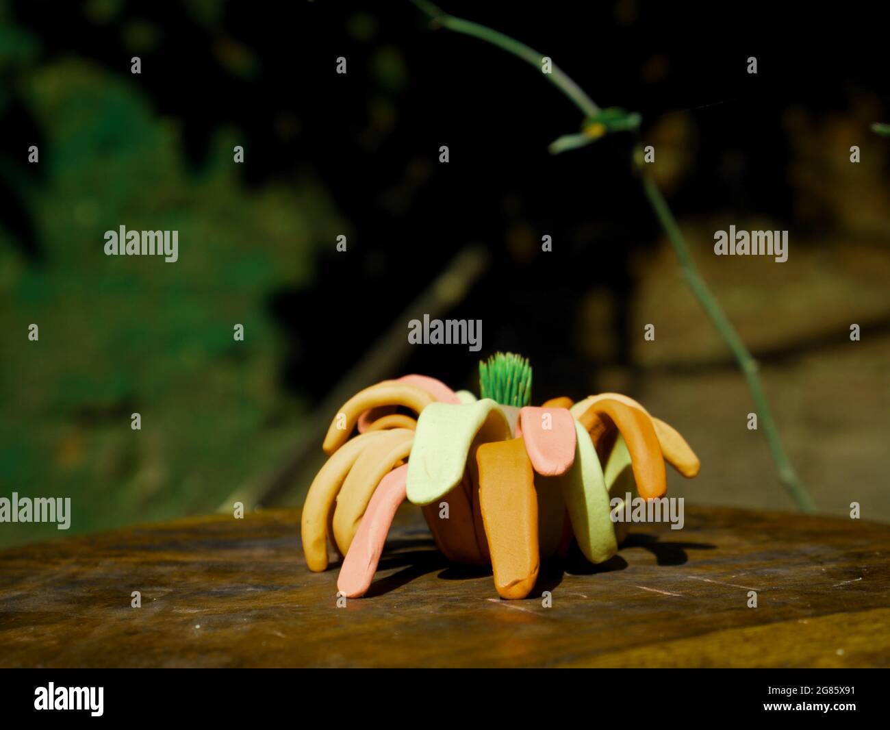 hand made clay art lotus flower kept on wooden surface at natural park ...