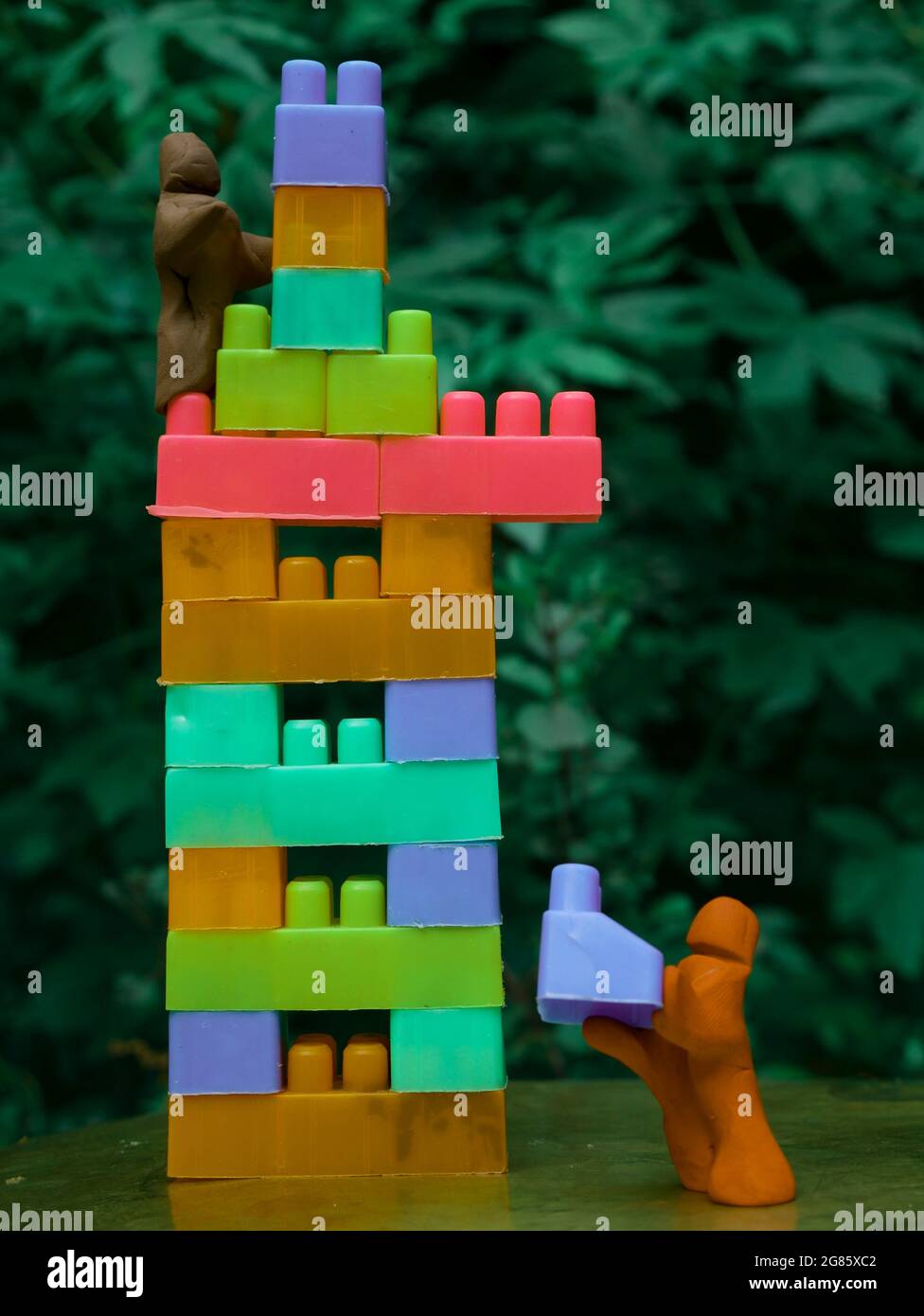 Clay statue building blocks house around natural green garden ...