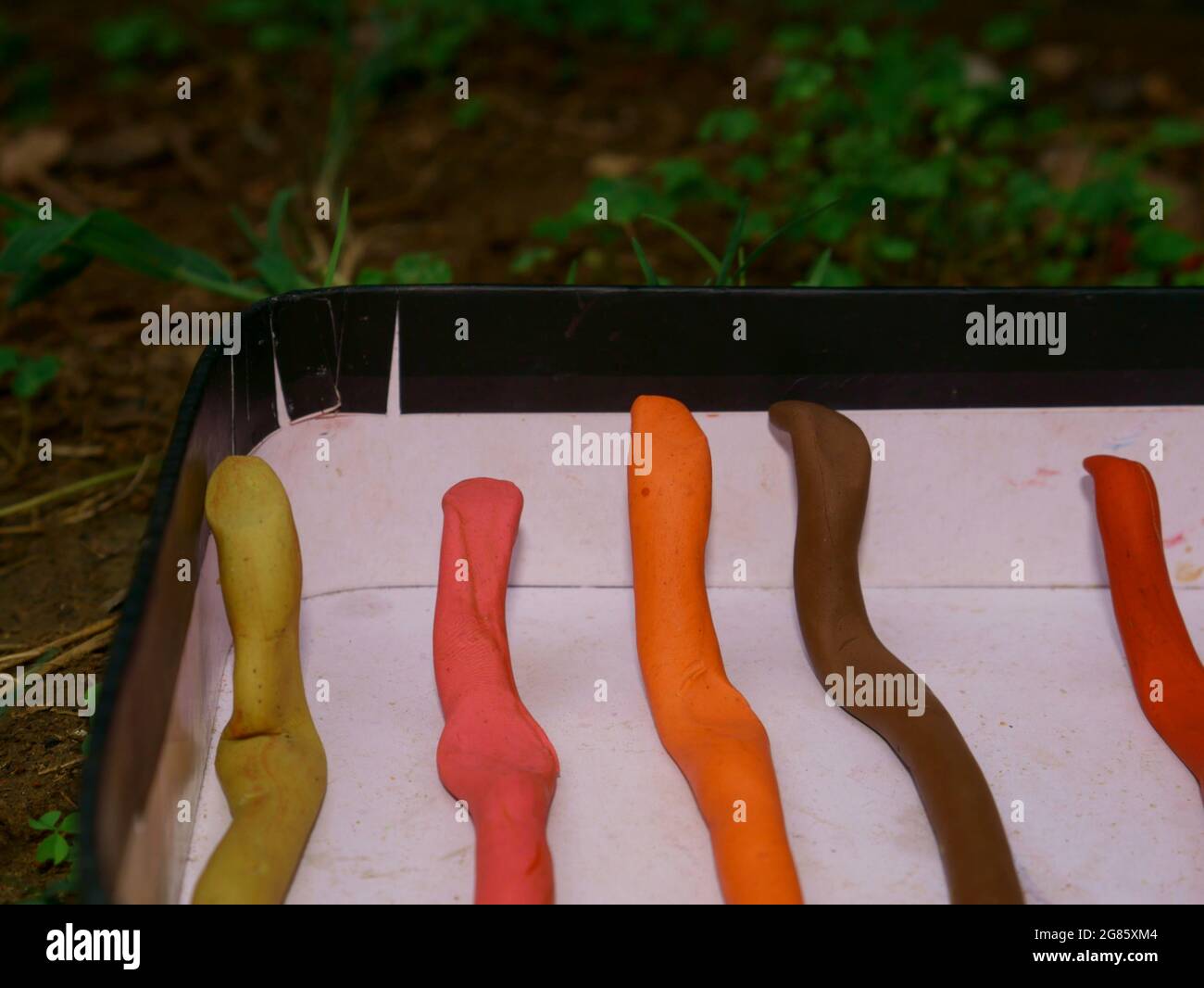 Multiple clay made snake soft toy kept on box, Animal art presentation ...