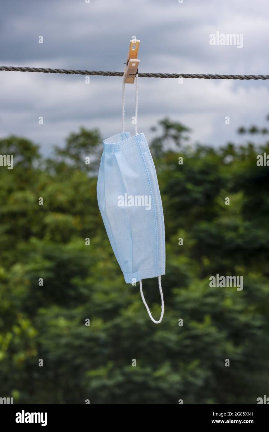 Hanging a surgical mask with a clothesline to dry Stock Photo - Alamy