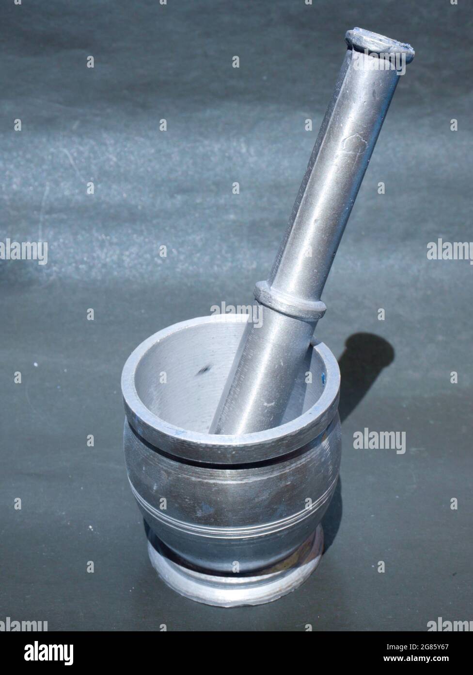 Silver metal food spice hand crusher isolate at black background ...