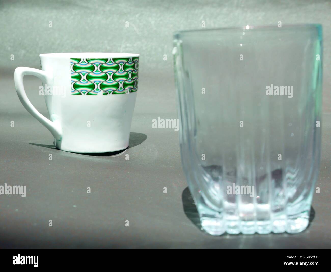 China soil made tea cup presented behind blur glass image on gray ...