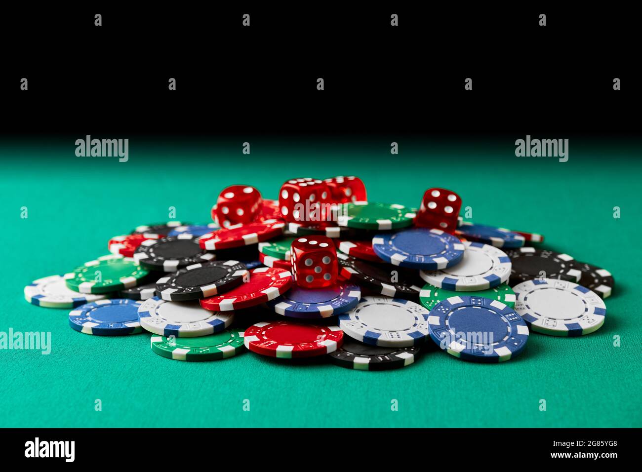 Pile of Casino pocker gambling chips and dices on green table Stock ...