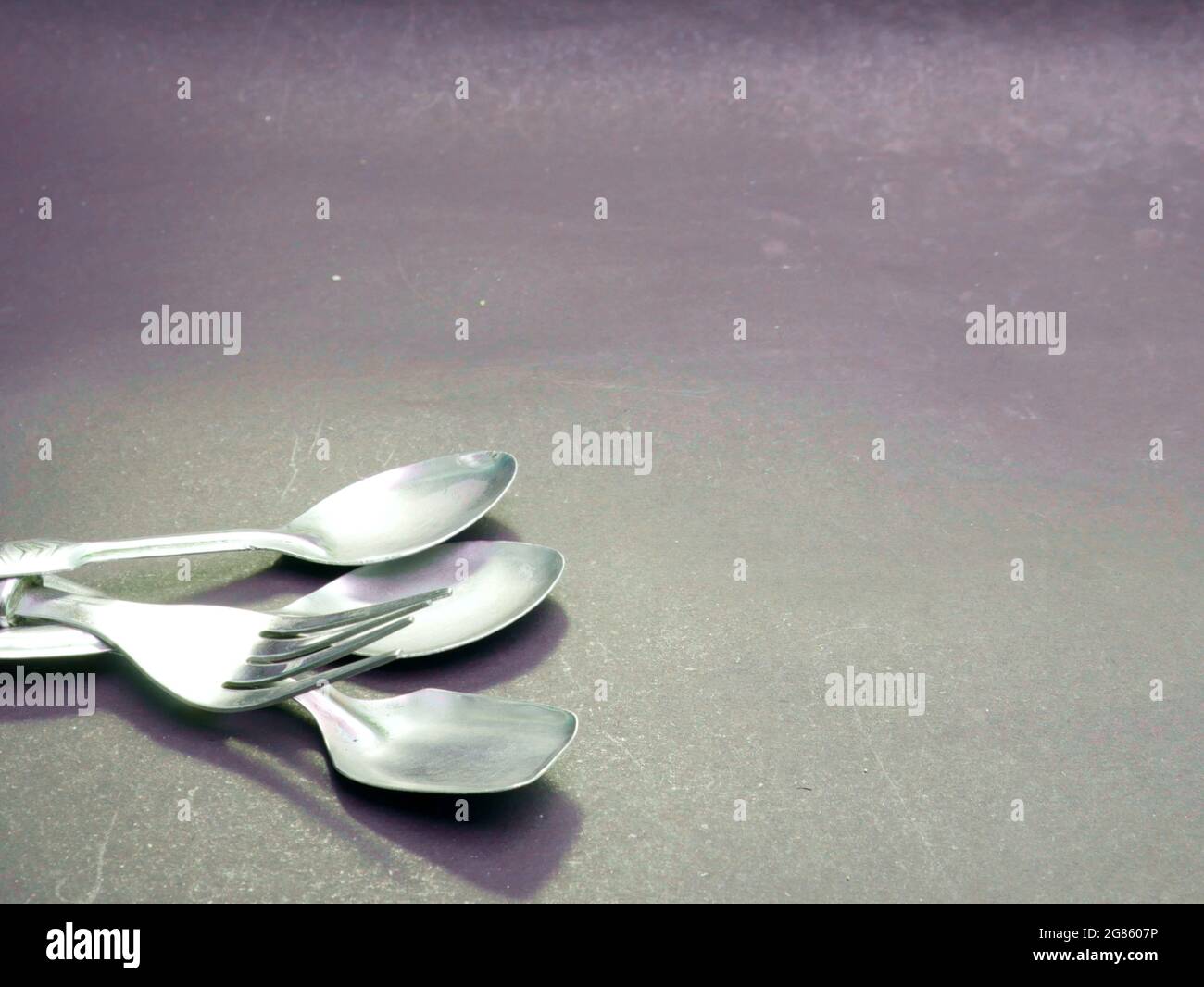 Fork and spoon set presented with text space side frame on gray ...