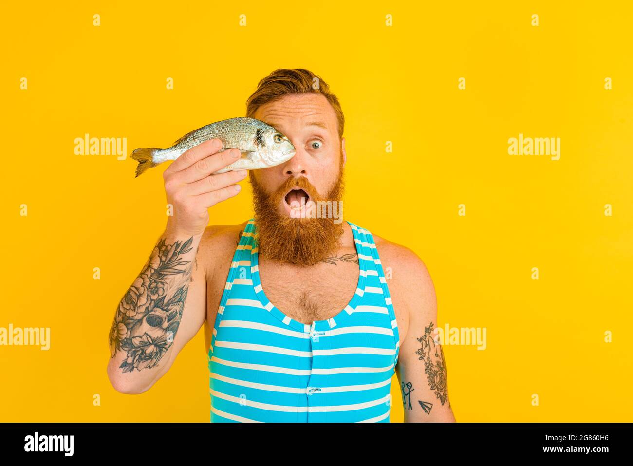 man with beard and swimsuit caught a fish Stock Photo - Alamy