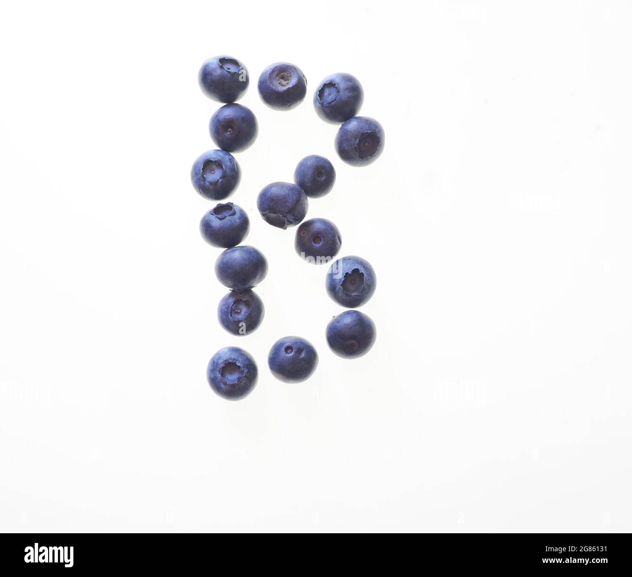 The letter B spelt out in blueberries against a white background Stock ...