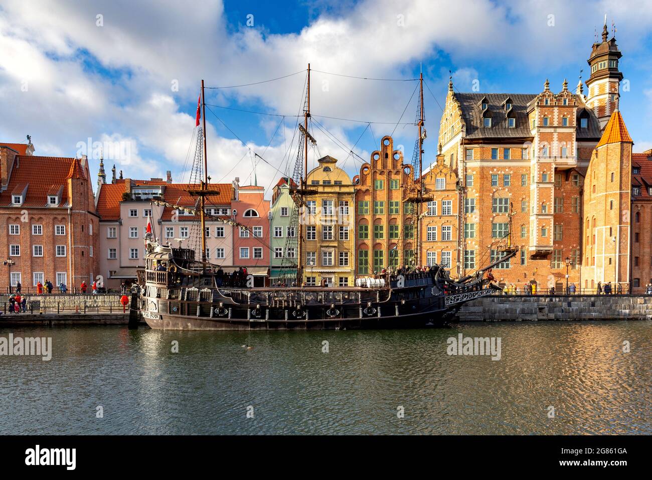 City embankment and facades of medieval houses in the old town on a ...
