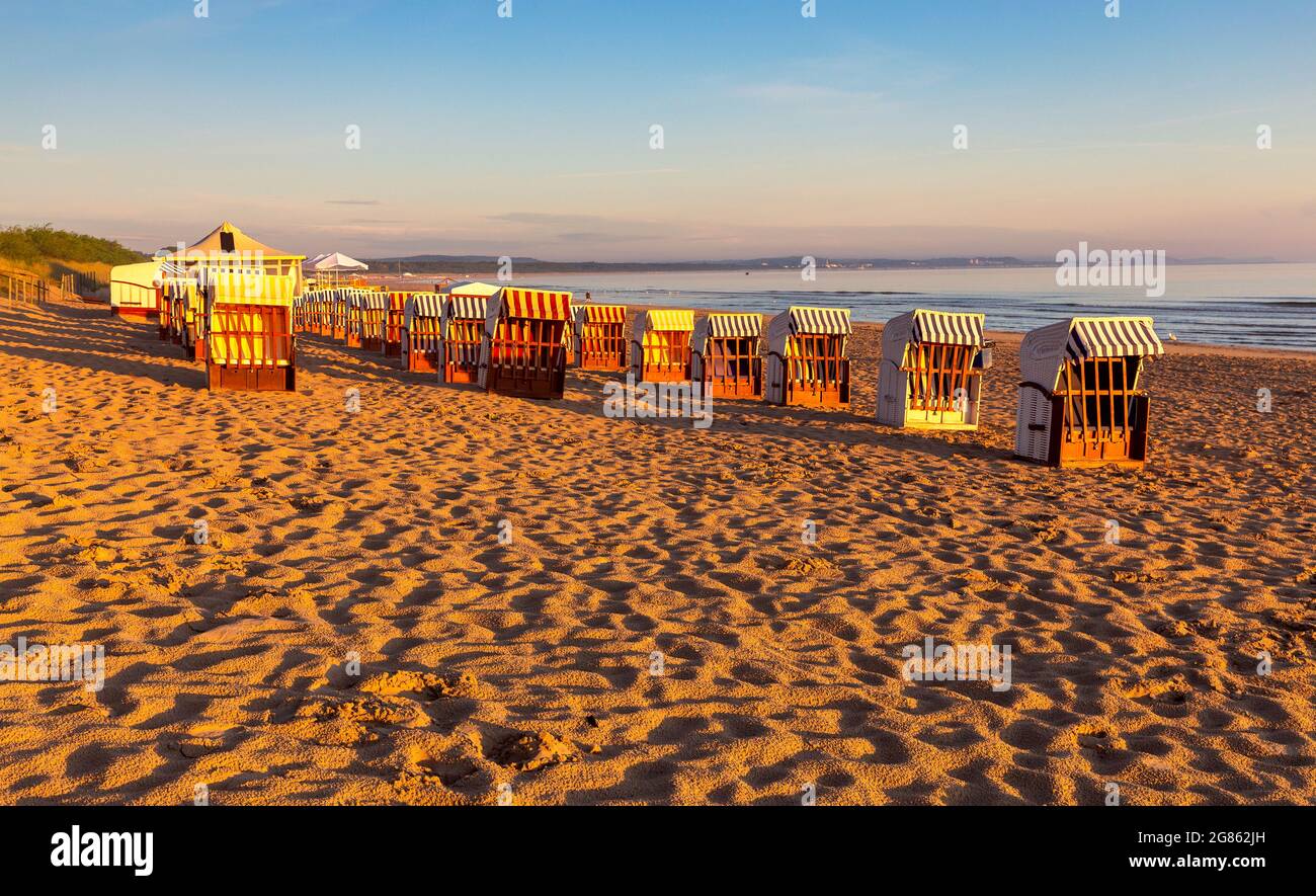 Traditional vintage old beach cabins on the sandy beach in the early ...