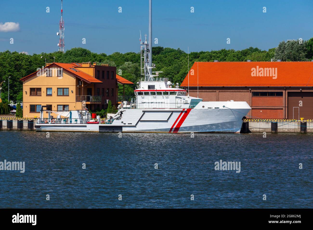 A sea vessel near the city embankment on a sunny day. Swinoujscie ...